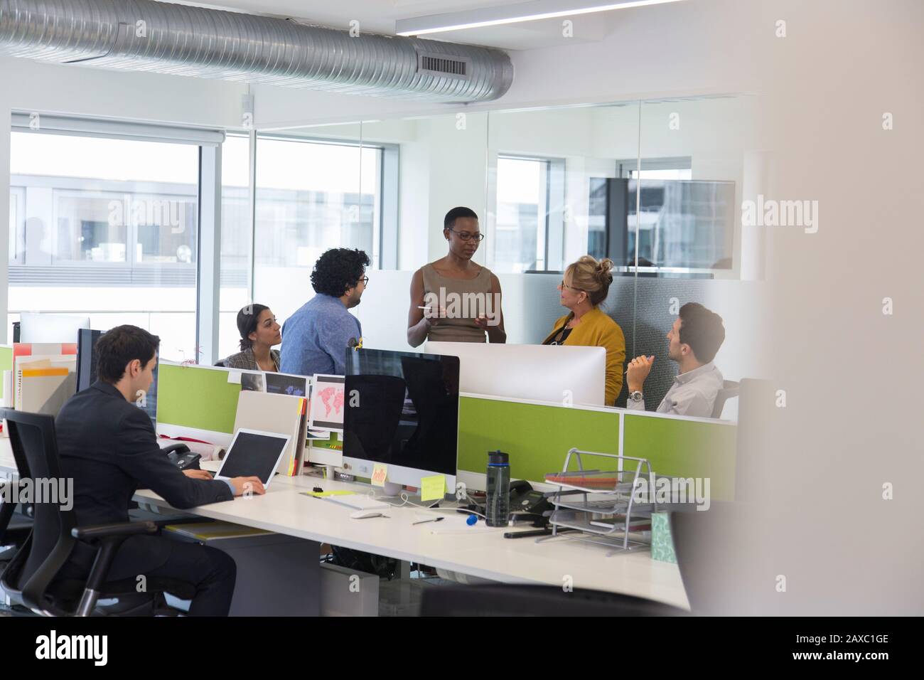 Business people talking, meeting in open plan office Stock Photo - Alamy
