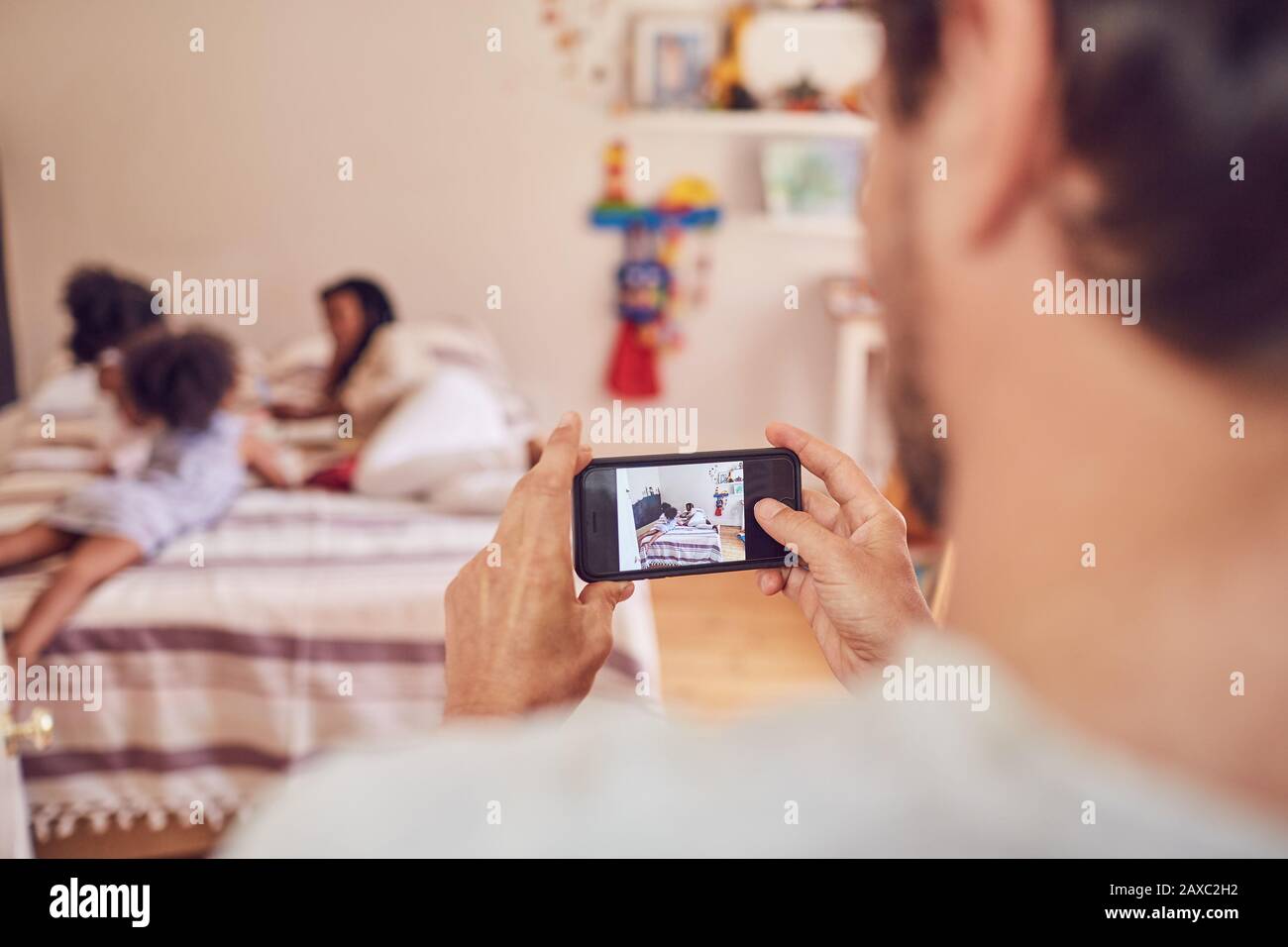 Father playing with his daughter on bed hi-res stock photography and ...