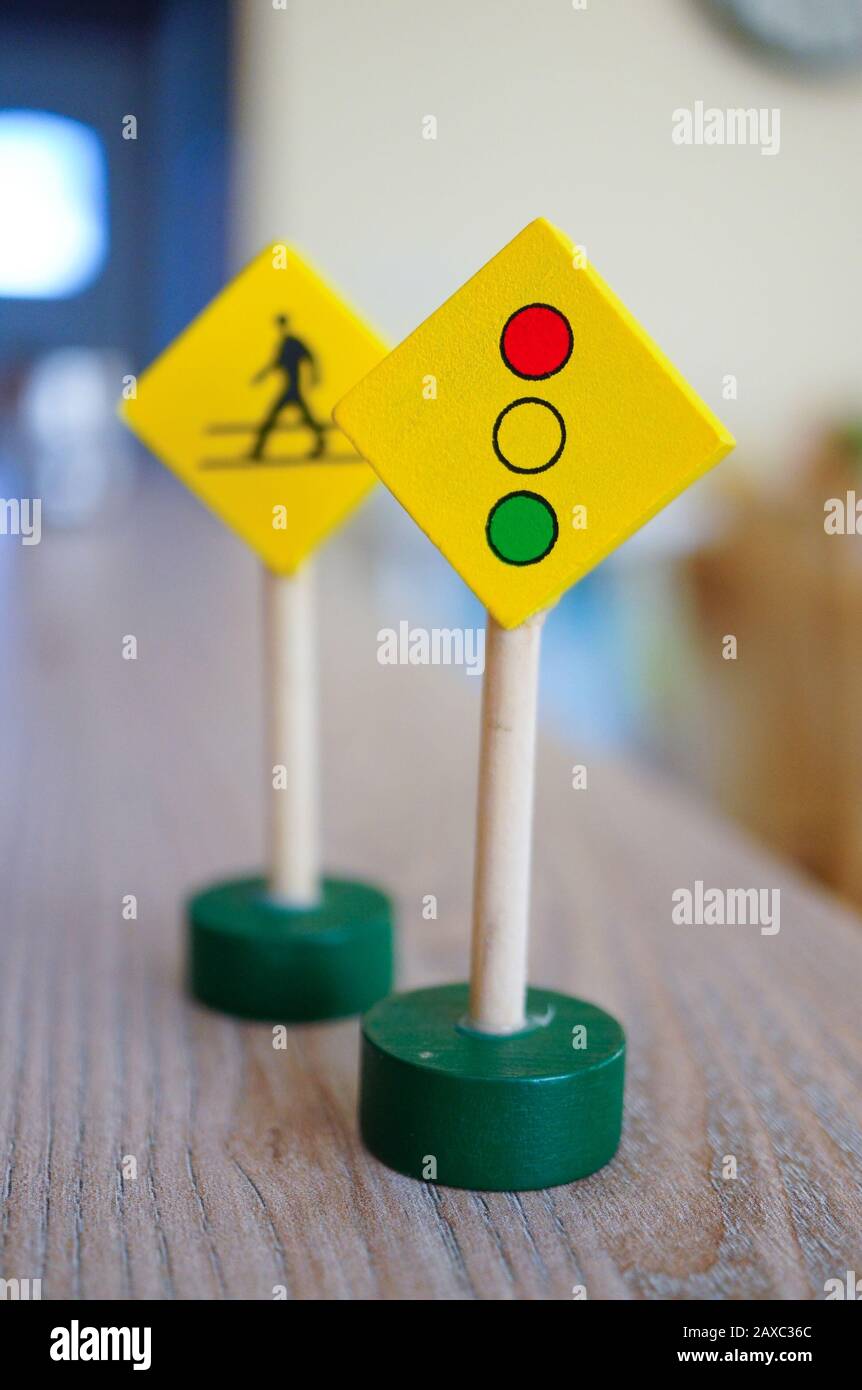 Closeup shot of a wooden traffic light toy with a pedestrian sign ...