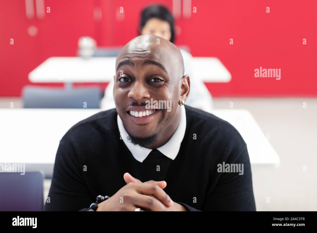 Portrait happy, confident male community college student in classroom ...