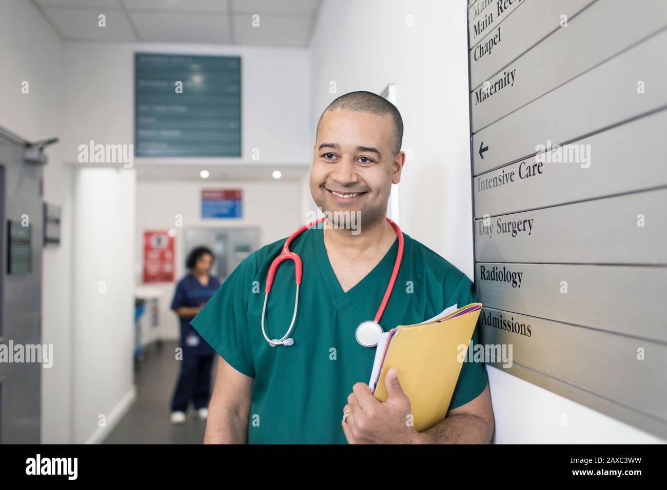 Portrait smiling, confident male surgeon in hospital corridor Stock ...
