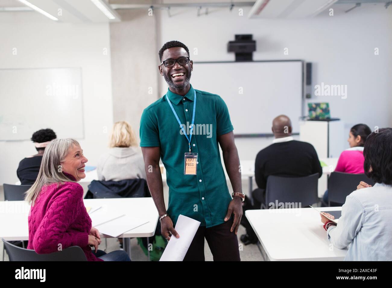 Portrait happy, confident male community college instructor leading ...