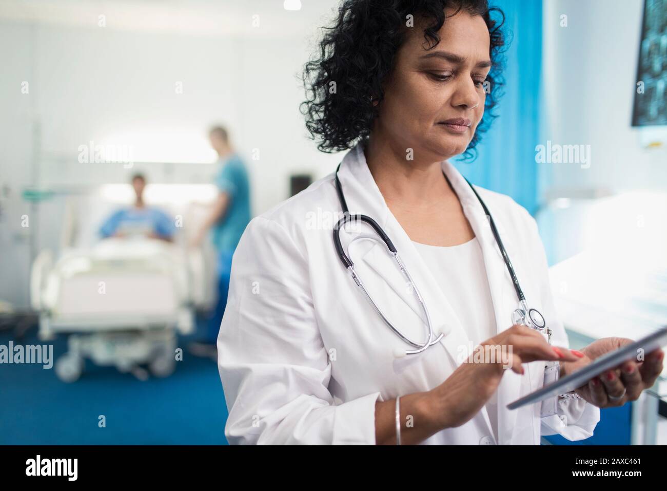 Female doctor using digital tablet in hospital room Stock Photo - Alamy