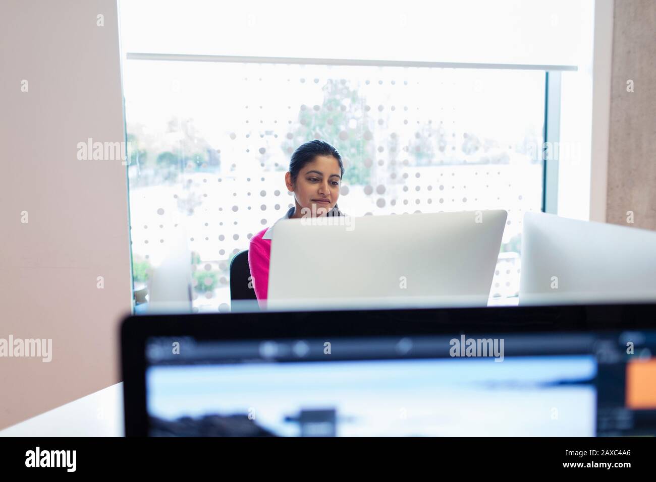 Dedicated female community college student using computer in computer ...