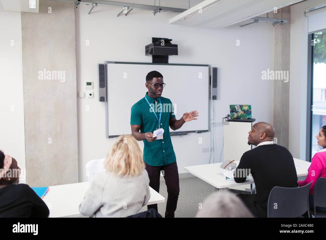 Community college students watching instructor leading lesson in ...