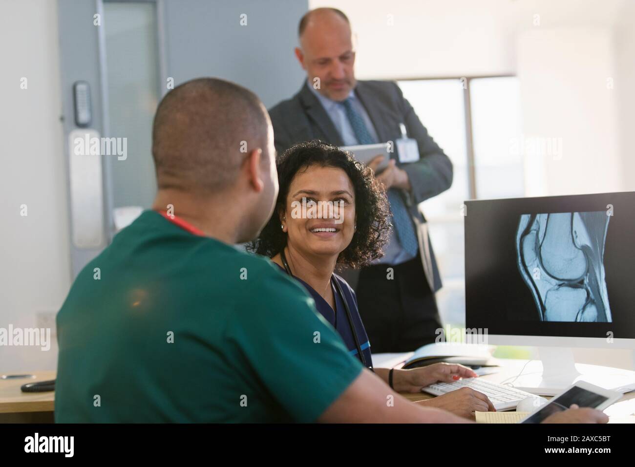 Nurses discussing digital x-ray at computer in doctors office Stock ...