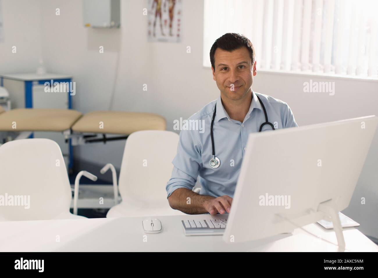 Doctor with computer looking at camera hi-res stock photography and ...