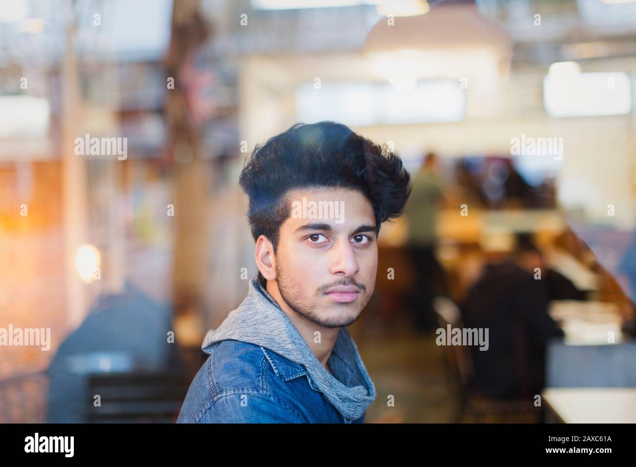 Portrait confident young man in cafe window Stock Photo - Alamy