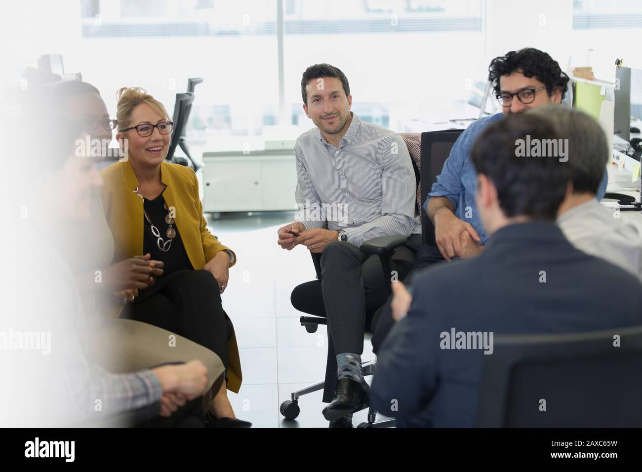 Business people meeting in a circle in office Stock Photo - Alamy