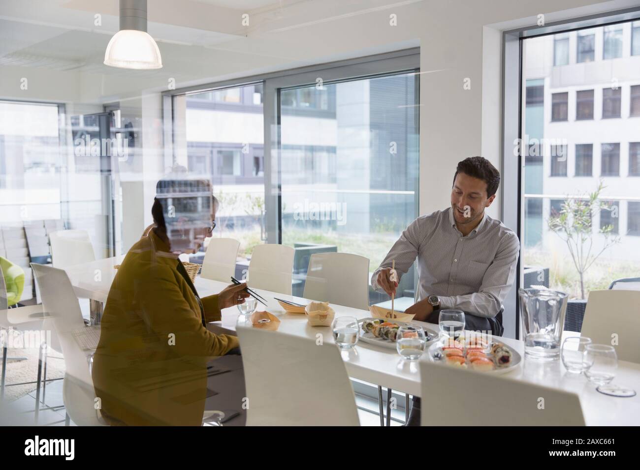 Business people eating sushi lunch in conference room Stock Photo - Alamy