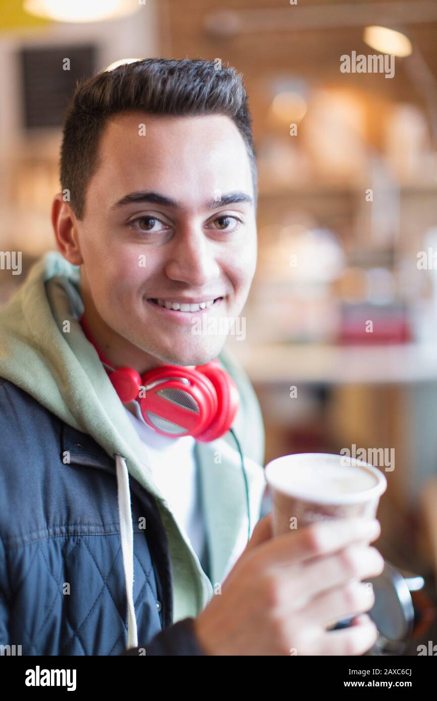 Portrait smiling, confident young man drinking coffee in cafe Stock ... Portrait smiling, confident young man drinking coffee in cafe Stock ...
