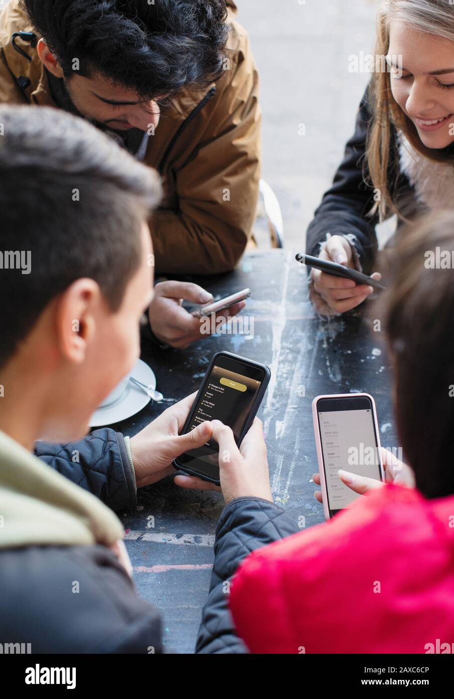 Young adult friends using smart phones Stock Photo - Alamy