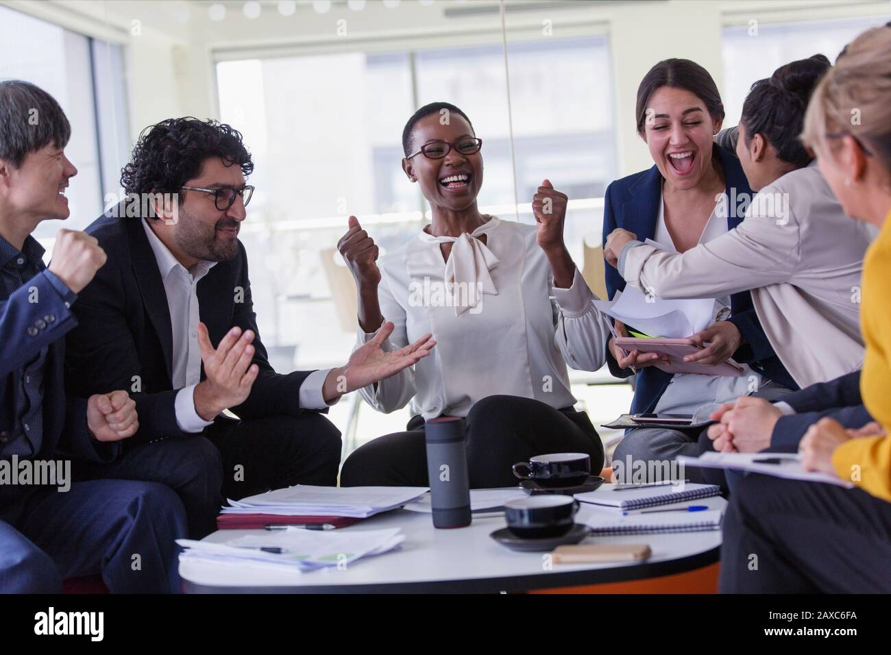 Excited business people cheering in meeting Stock Photo - Alamy