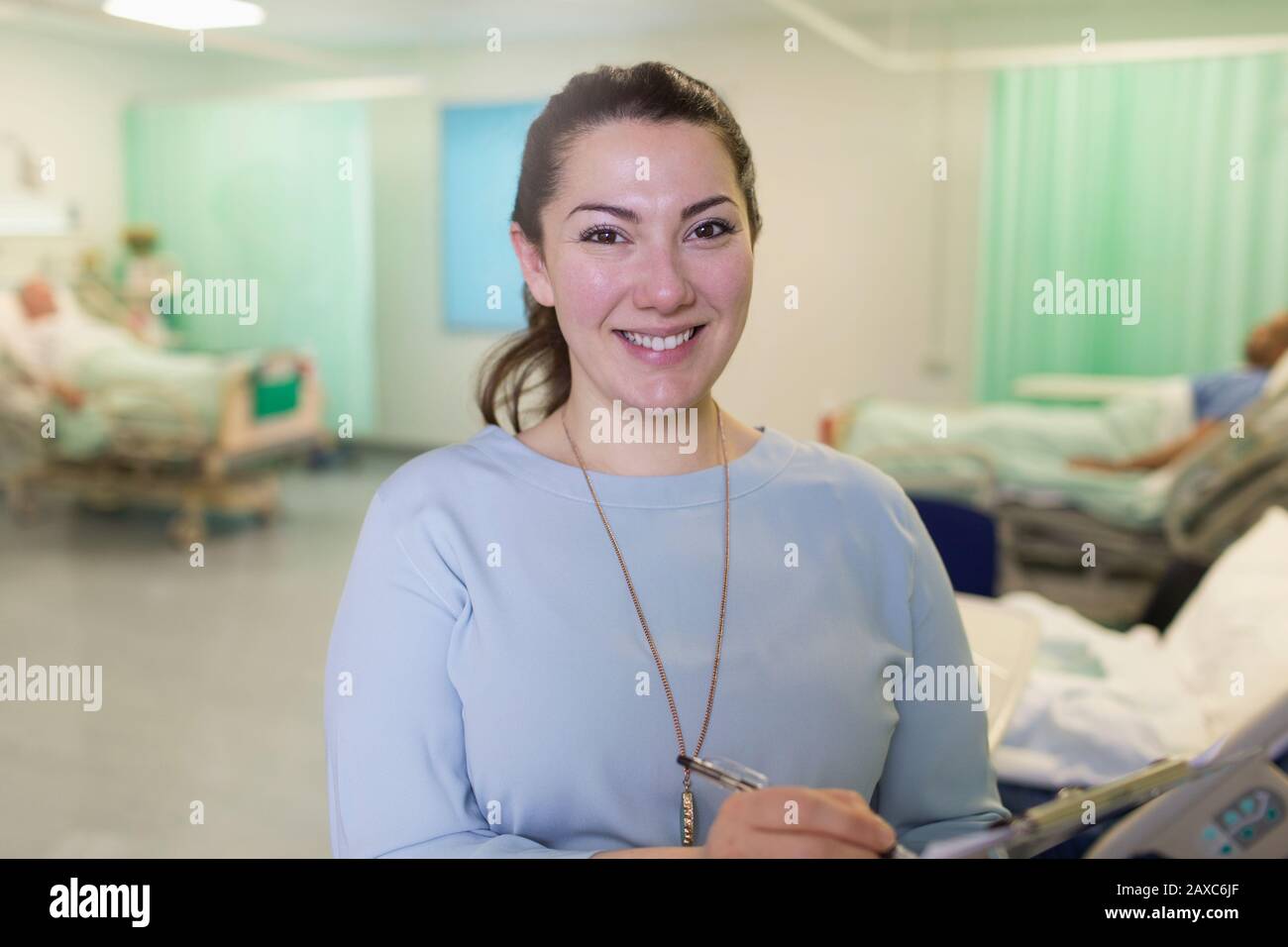 Portrait confident female doctor making rounds in hospital ward Stock ...