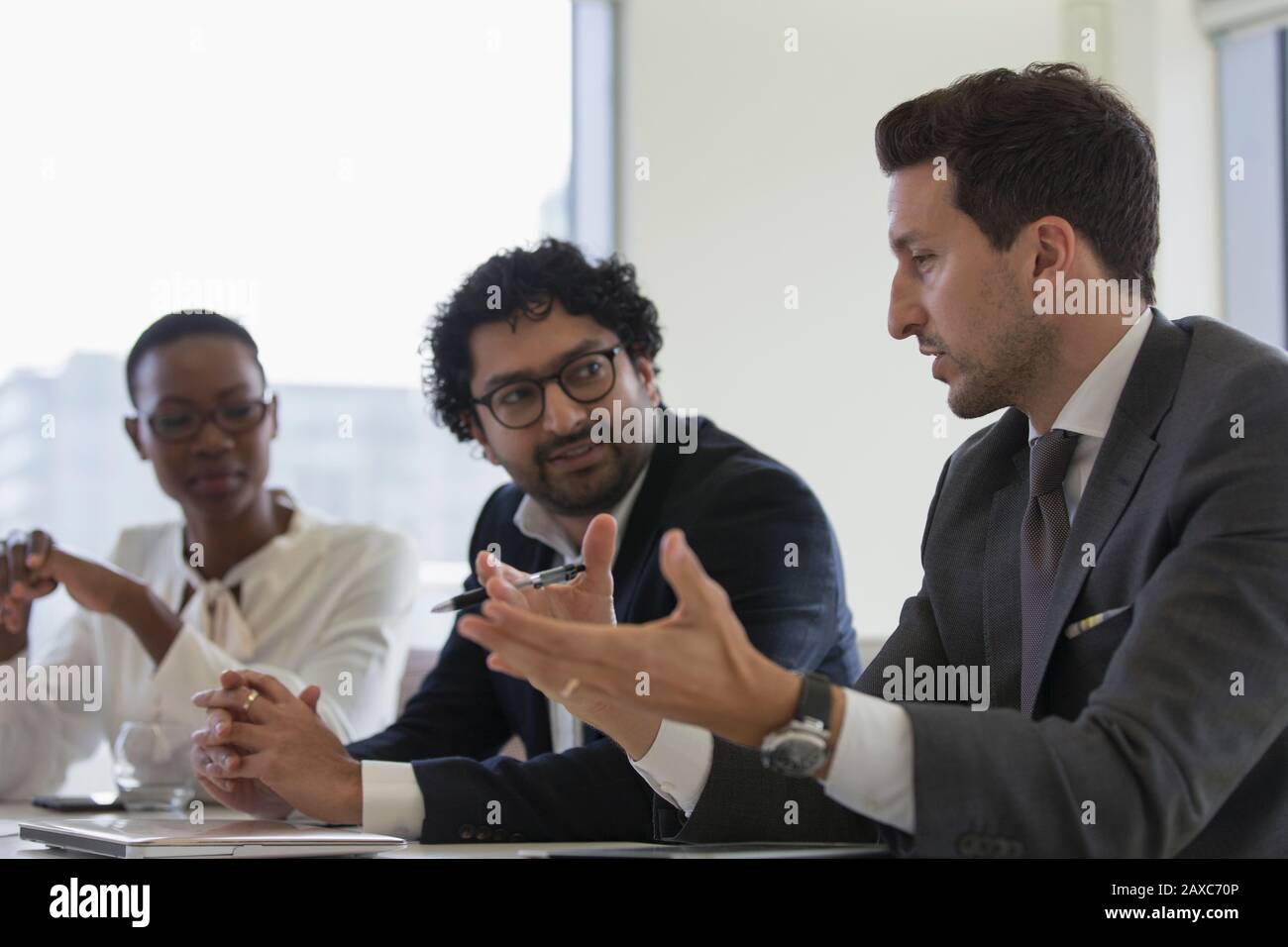 Businessman talking during conference room meeting Stock Photo - Alamy