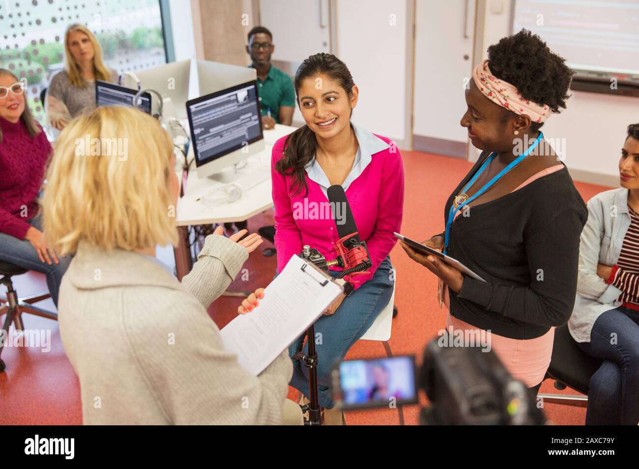 Community college journalism students at microphone in classroom Stock ...
