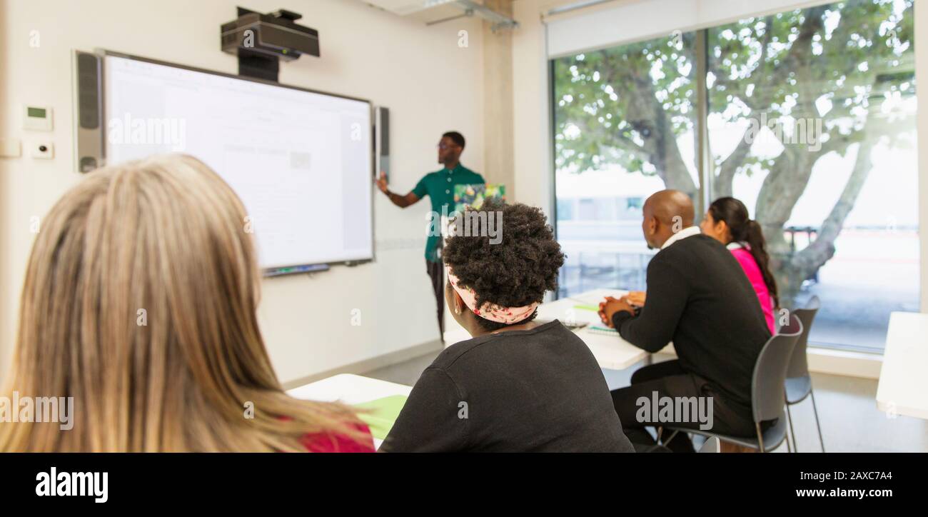 Community college students watching instructor leading lesson at ...