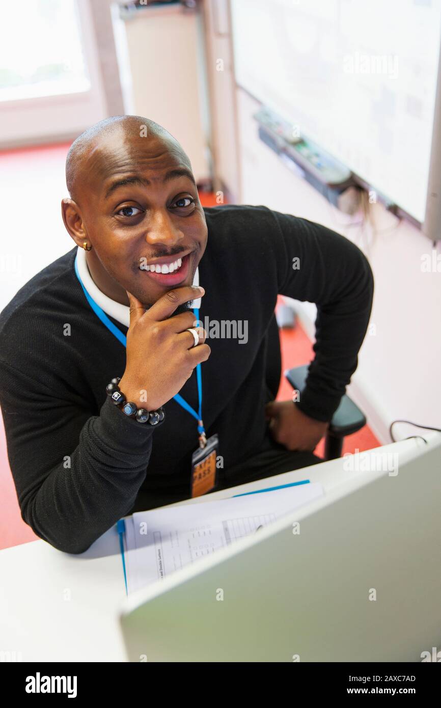 Portrait confident, smiling male community college instructor at ...
