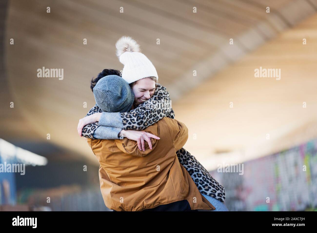 Happy young couple hugging Stock Photo - Alamy