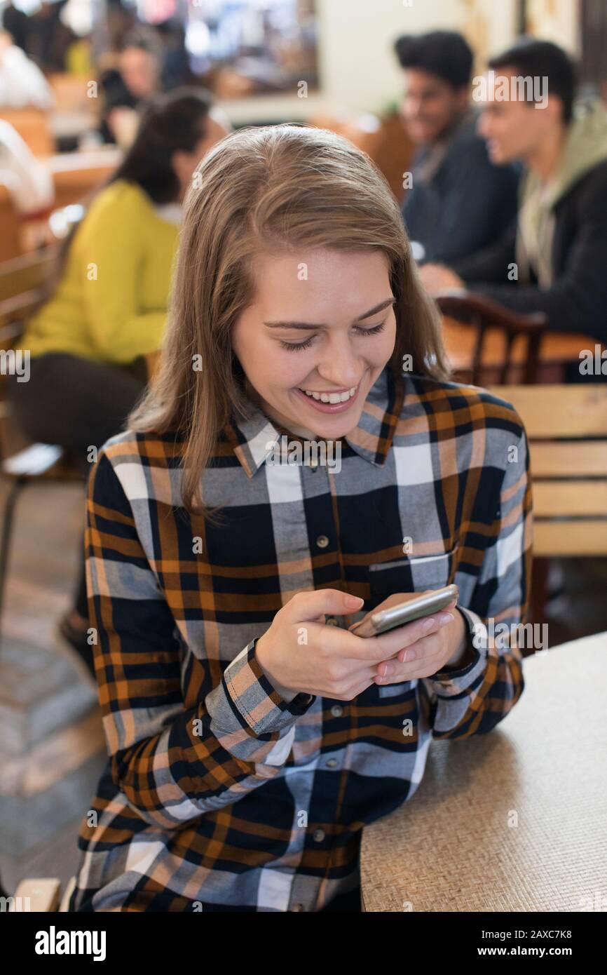 Young woman enjoying watching phone hi-res stock photography and images ...