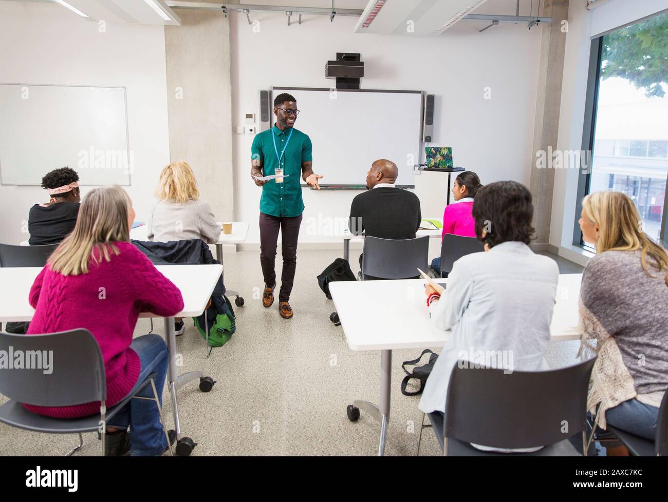 Community college students watching instructor leading lesson in ...