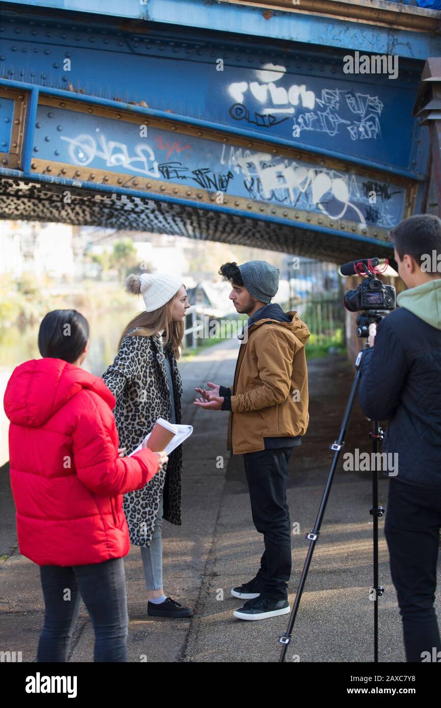 College film students filming under urban bridge Stock Photo - Alamy