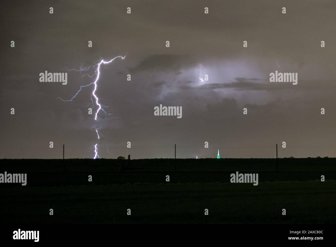 Striking nature image of a lightning bolt jumping out of a storm cloud ...