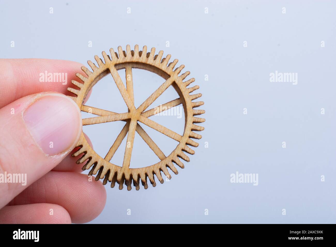 Hand holding gear wheels as the concept of mechanism Stock Photo - Alamy