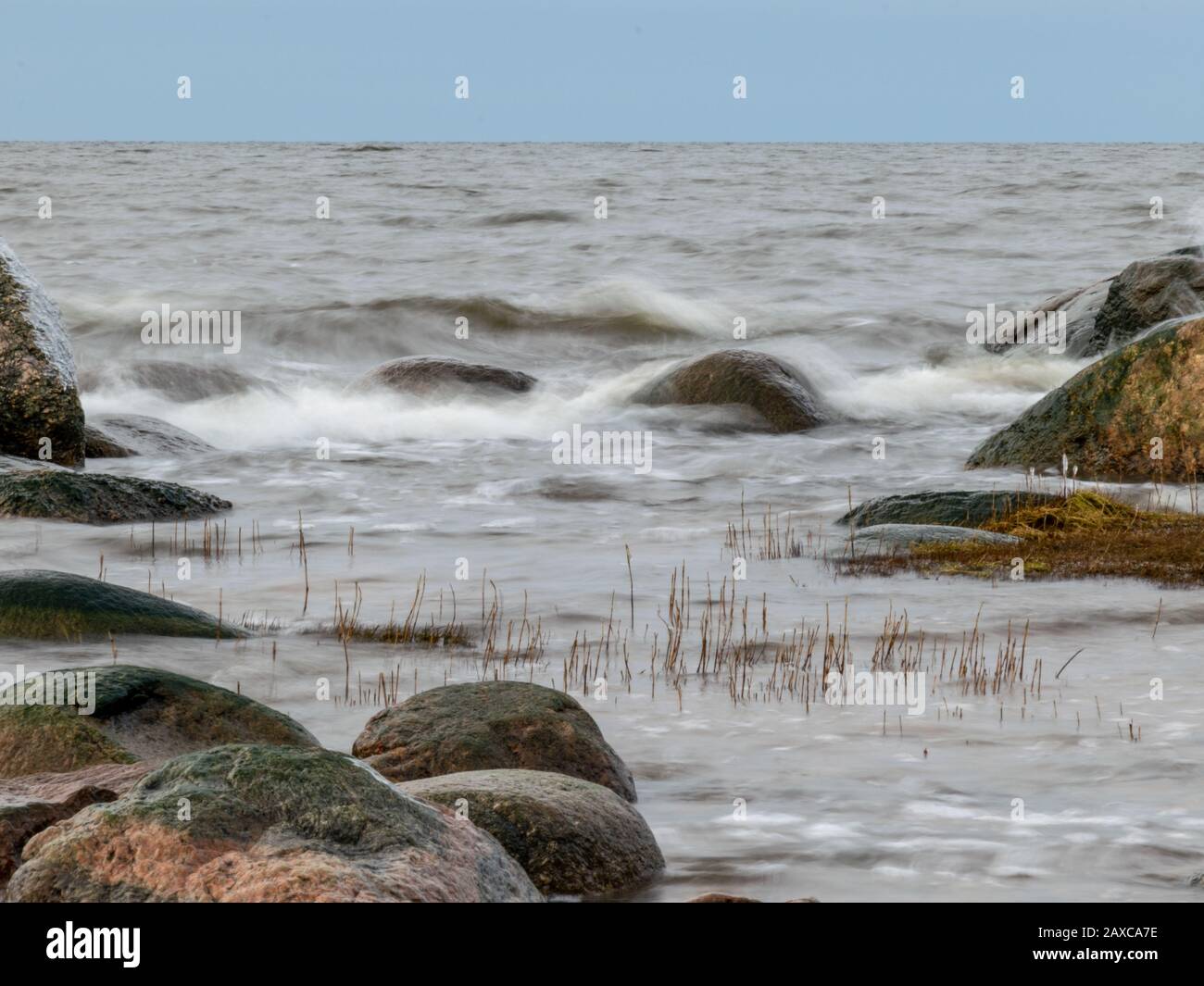 landscape with stony beach, stones of various shapes in the sea Stock ...