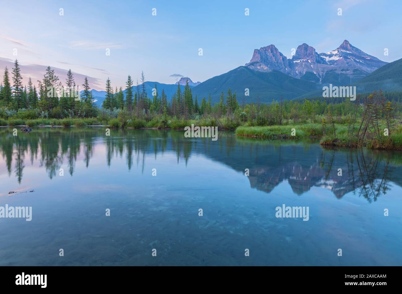 The Three Sisters Mountain Peaks and their reflections at early dawn ...