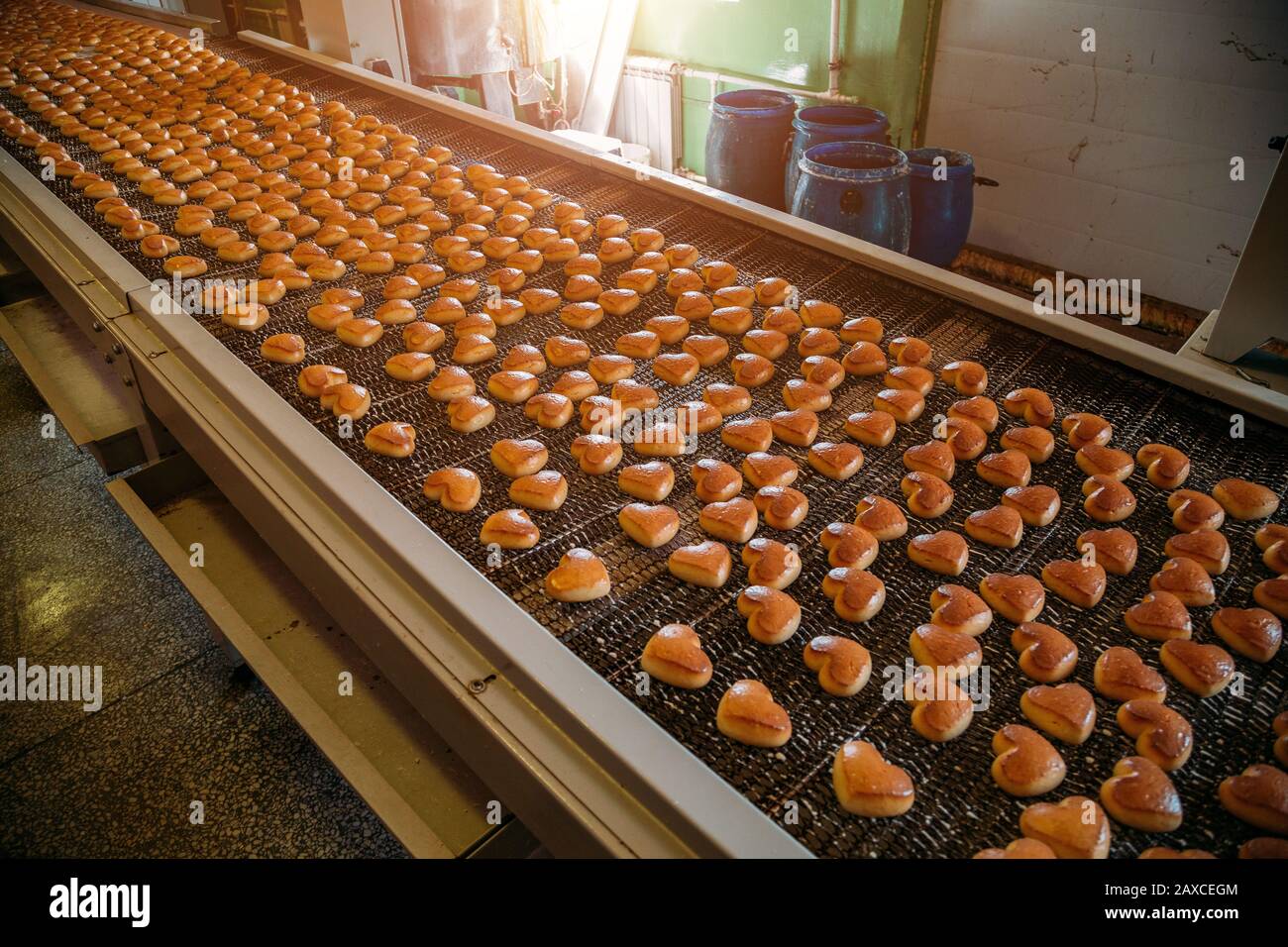 Baking production line. Cookies in form of hearts after glaze coating ...