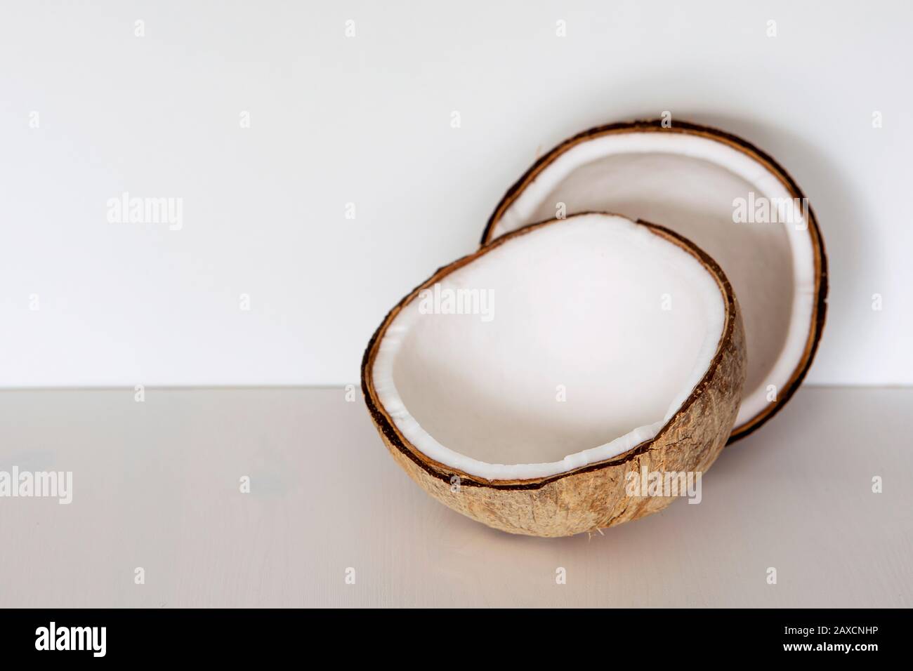 Fresh coconut on white background with copy space. Nut cut in half ...