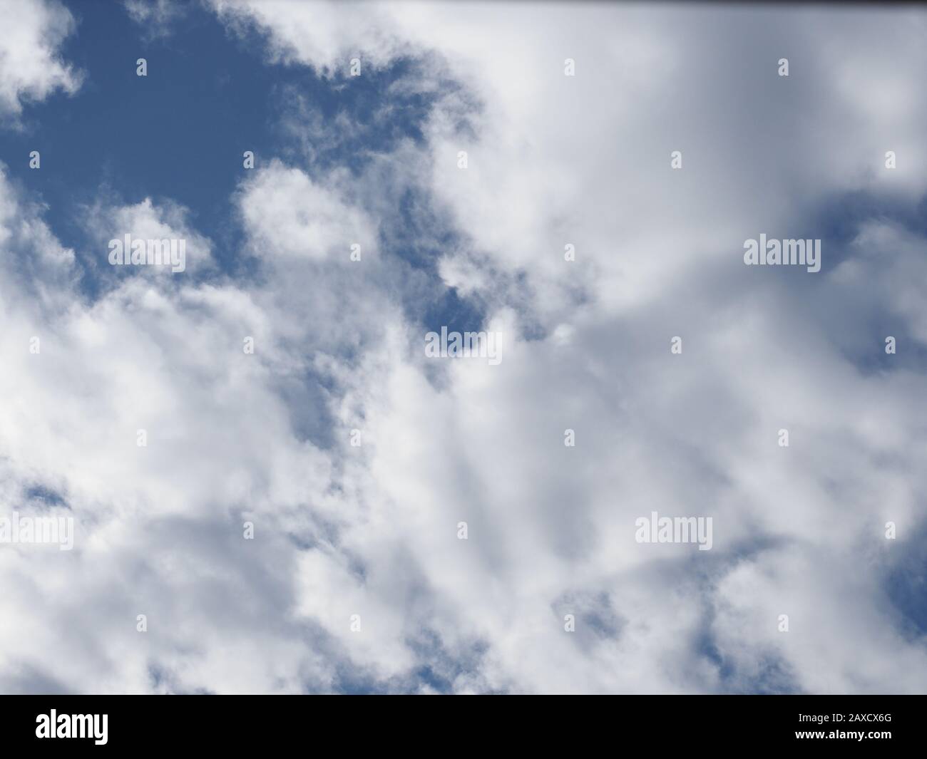 blue sky with clouds useful as a background Stock Photo - Alamy