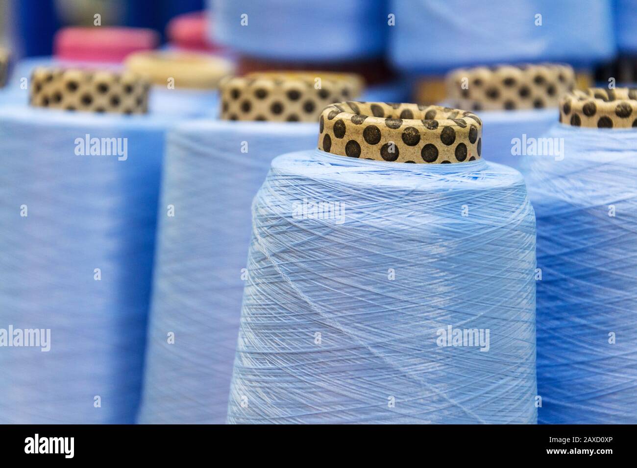 Colorful thread reels set up for sewing machine, textile industry ...