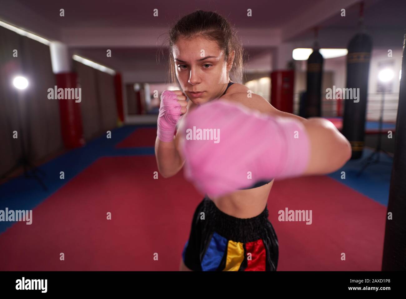 Kickboxer girl shadow boxing and kicking Stock Photo - Alamy
