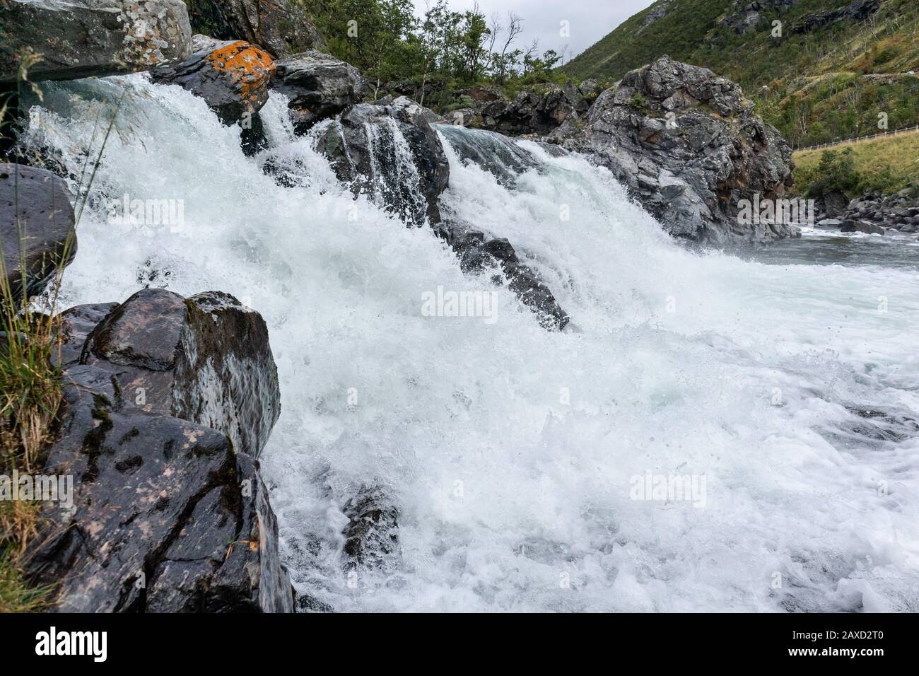 White powerful waterfall macro with water drops and beautiful mountains ...
