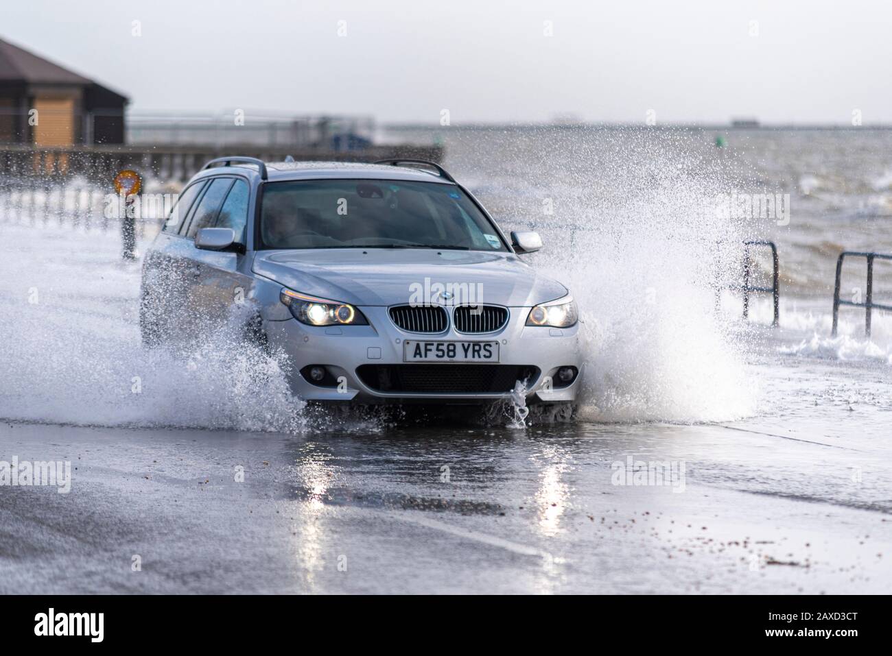 BMW driving through salt water of the flooded Western Esplanade of ...
