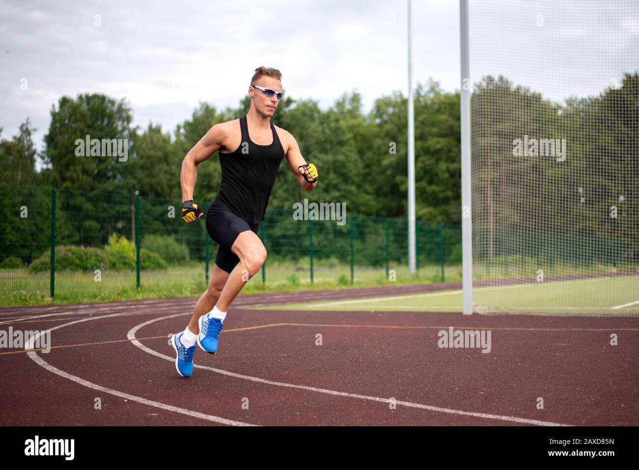 Muscular male runner running hi-res stock photography and images - Alamy