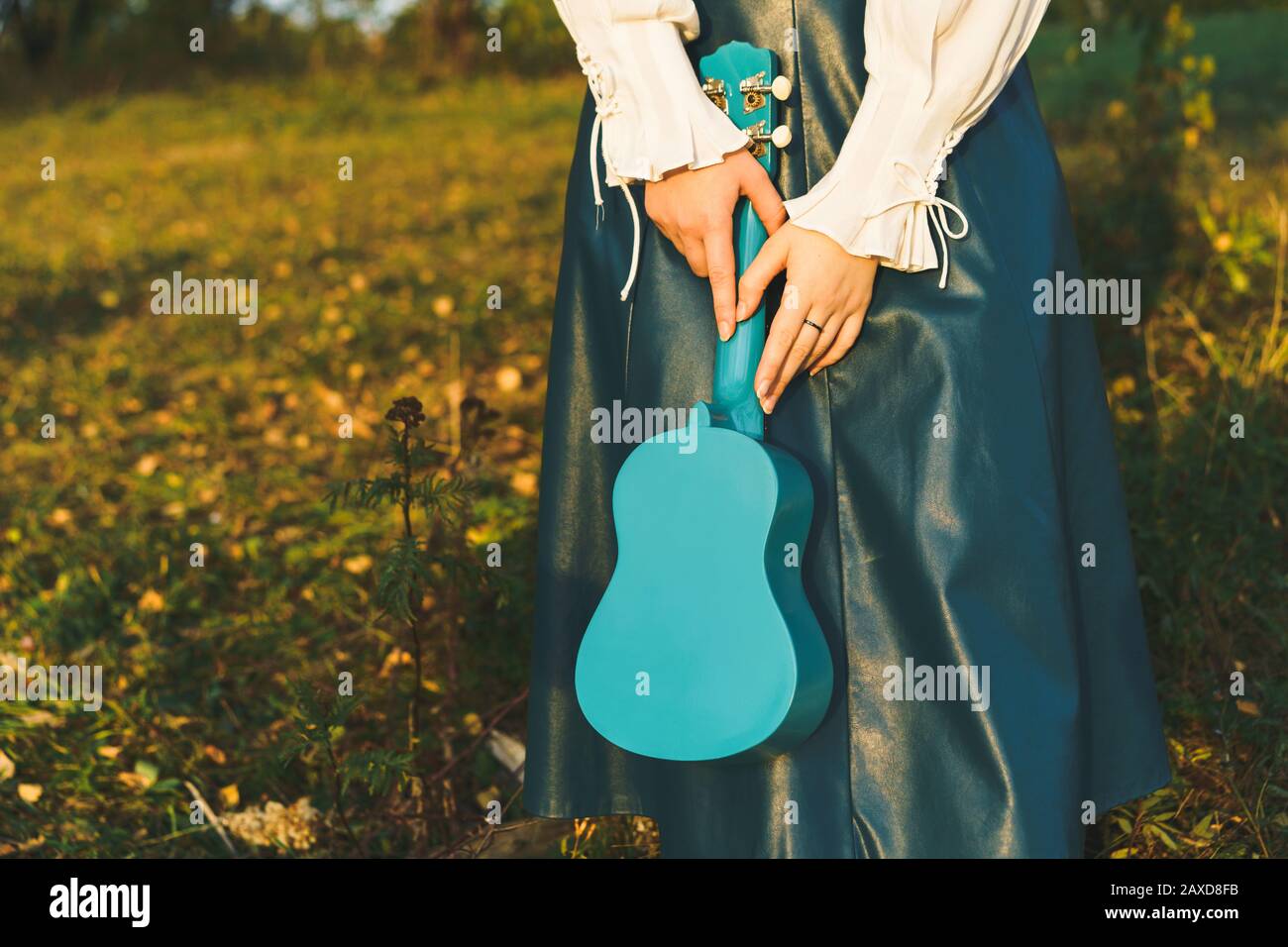 Young woman in a turquoise skirt and a white shirt Stock Photo - Alamy