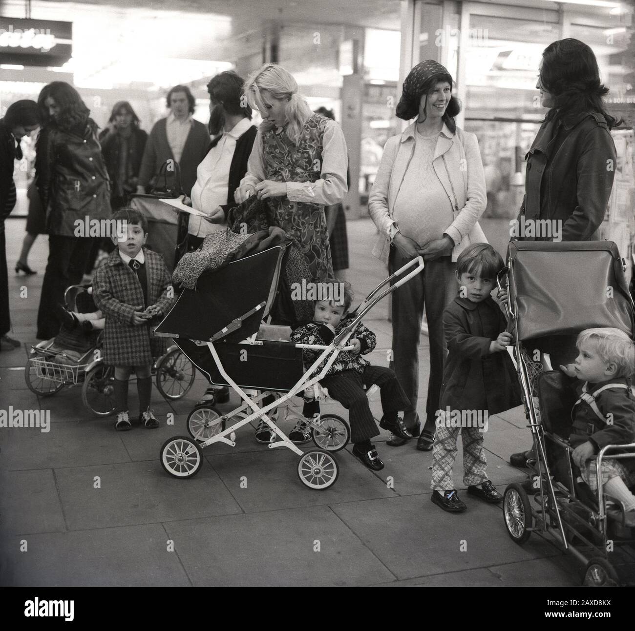 1970s, historical, new mothers and pregnant women gather together with ...