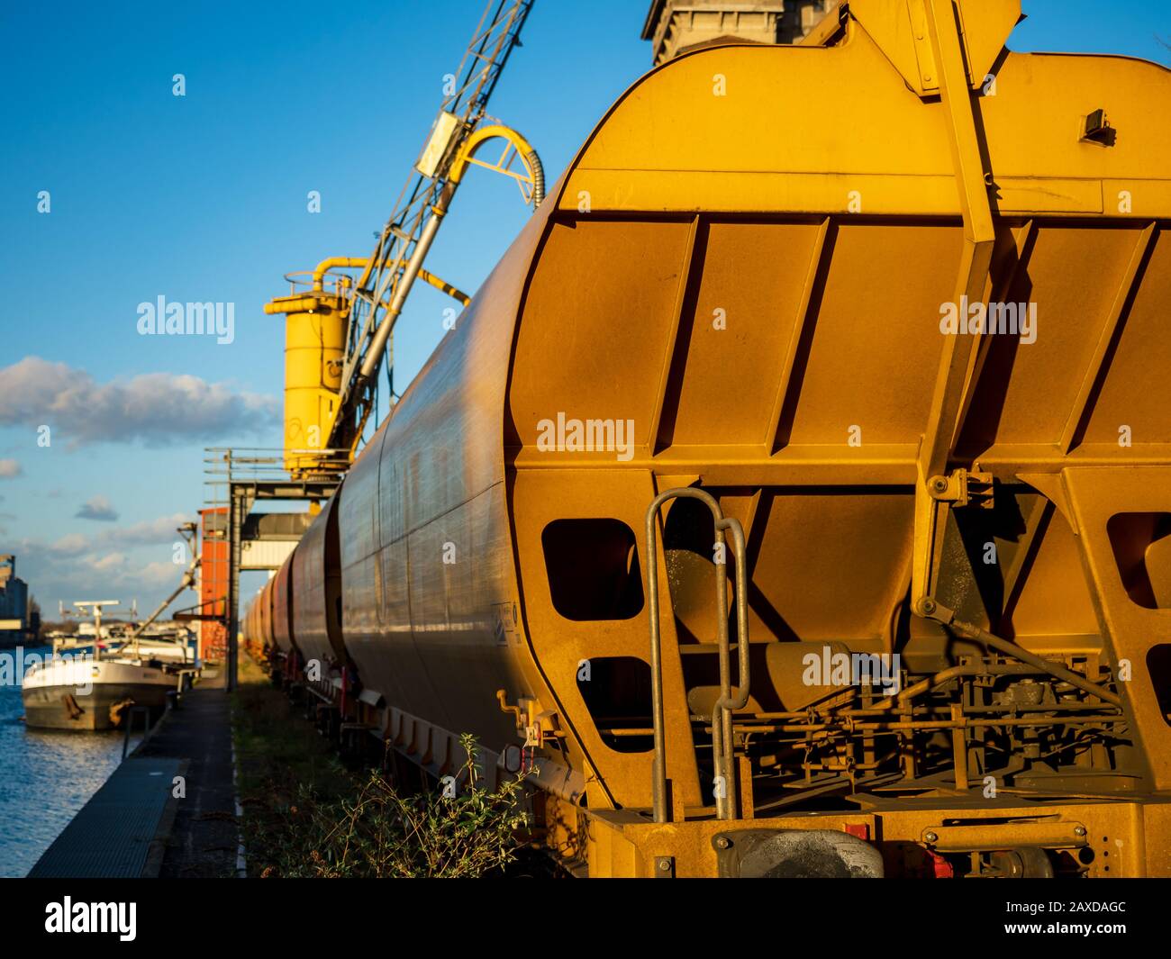 Bright yellow railway freight car against the blue sky in the port of ...