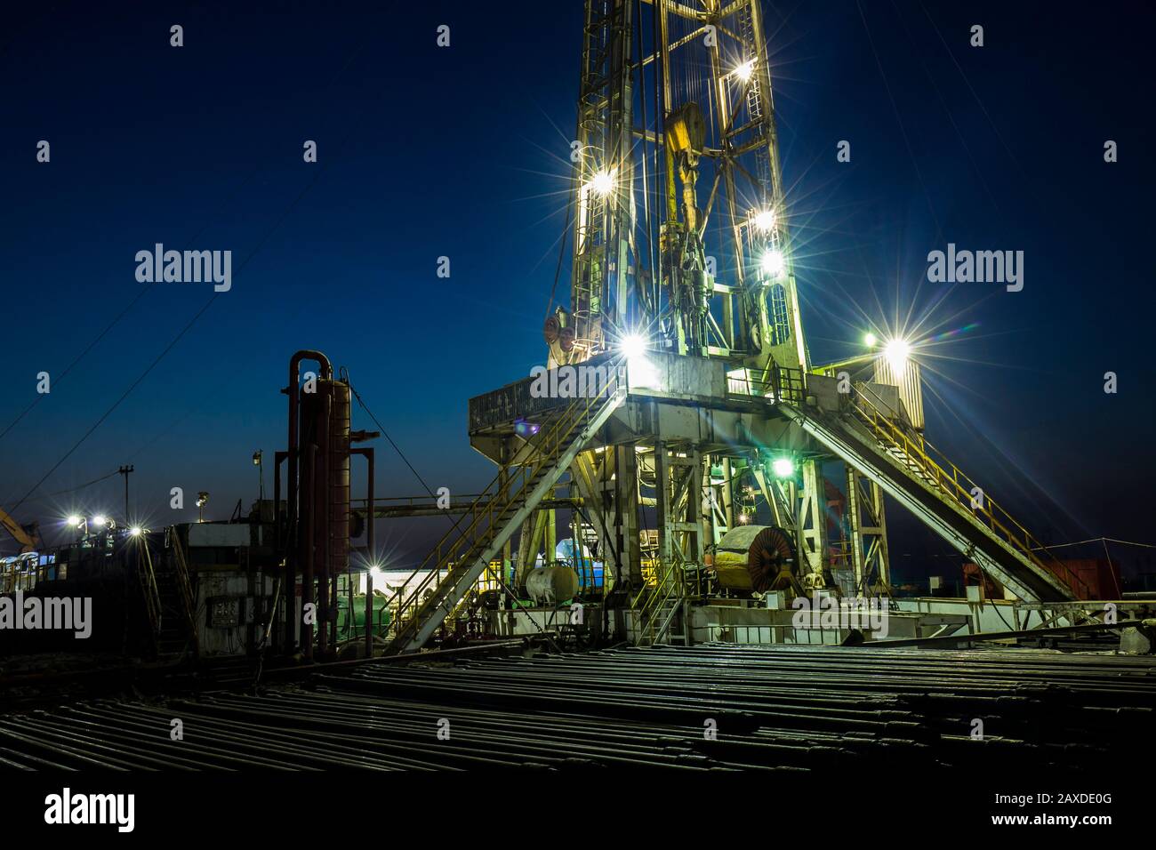 In the evening of oilfield derrick Stock Photo - Alamy