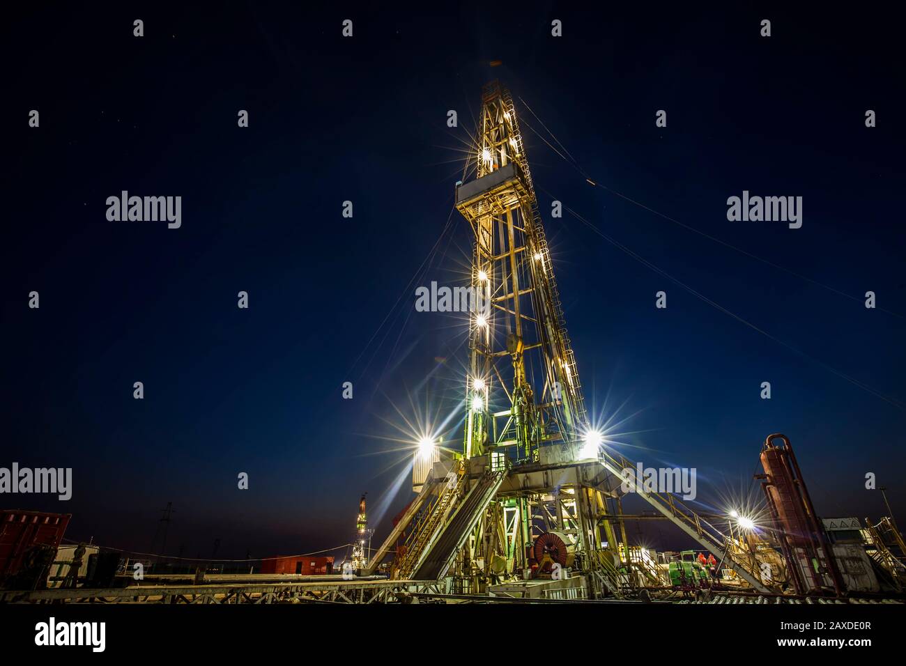 In the evening of oilfield derrick Stock Photo - Alamy
