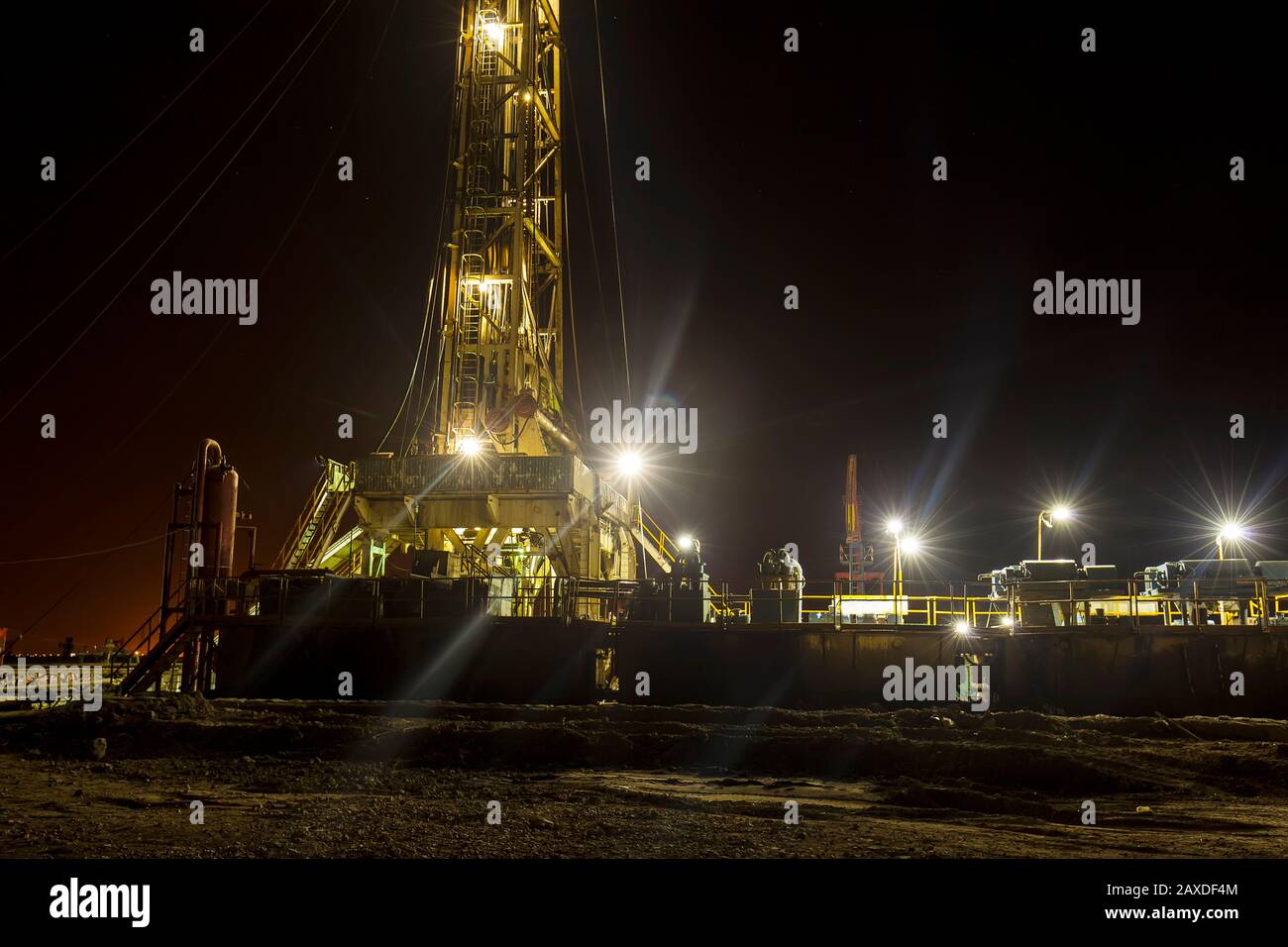In the evening of oilfield derrick Stock Photo - Alamy
