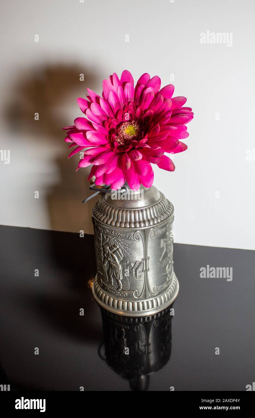 old tin cup with a fabric flower inside Stock Photo - Alamy