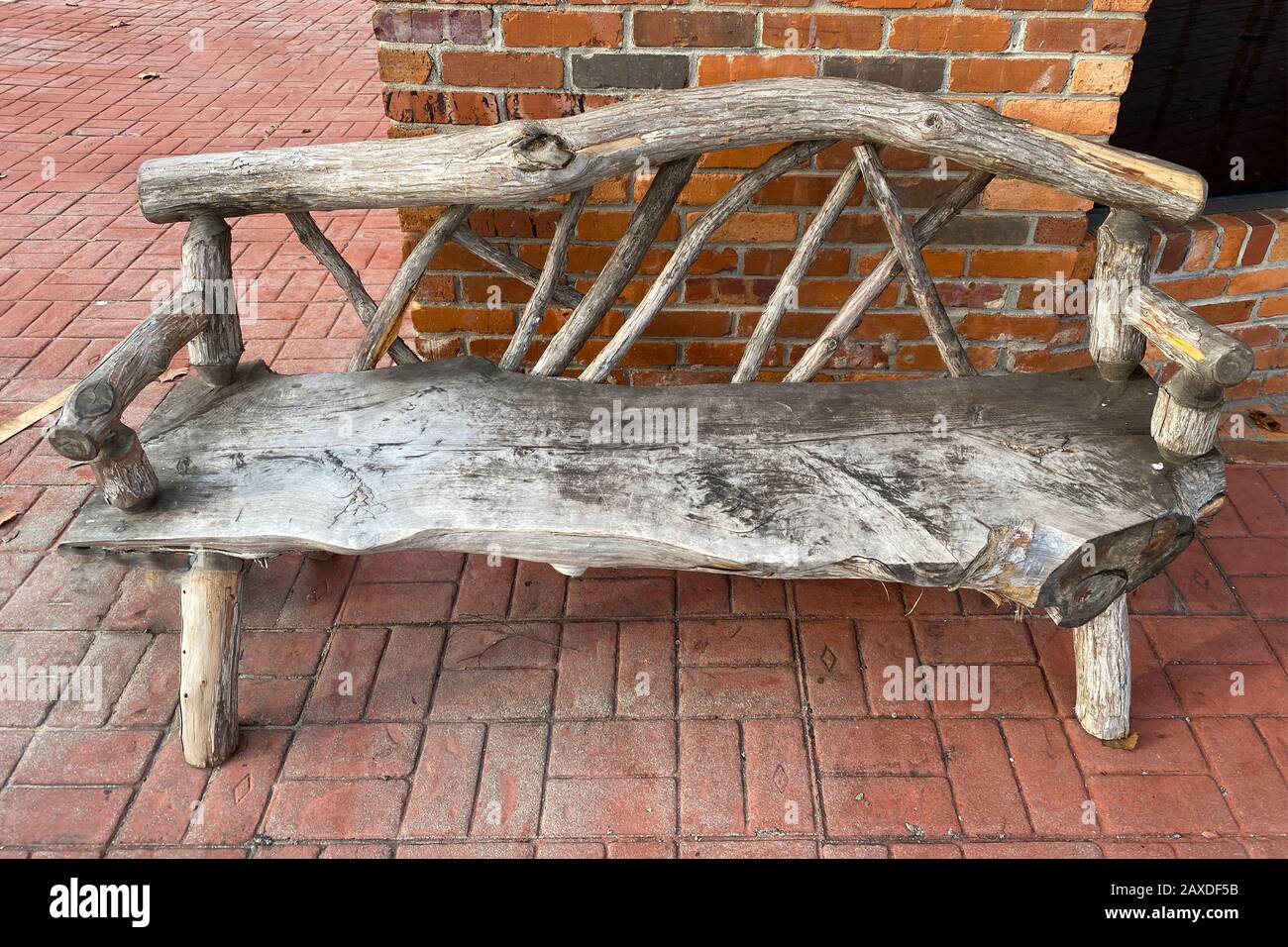 a handmade carved wooden tree branch park bench Stock Photo - Alamy