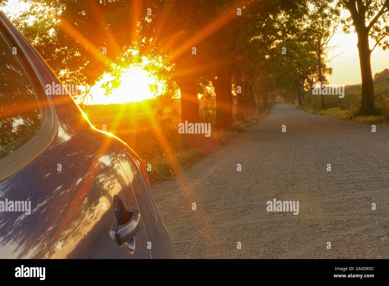 the sunset and the car, the sun's rays blue cars on the road Stock ...