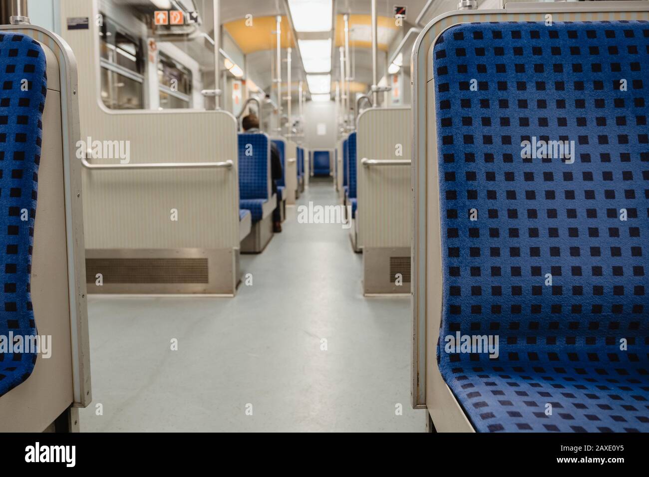 Interior view of a corridor inside passenger trains with blue fabric ...