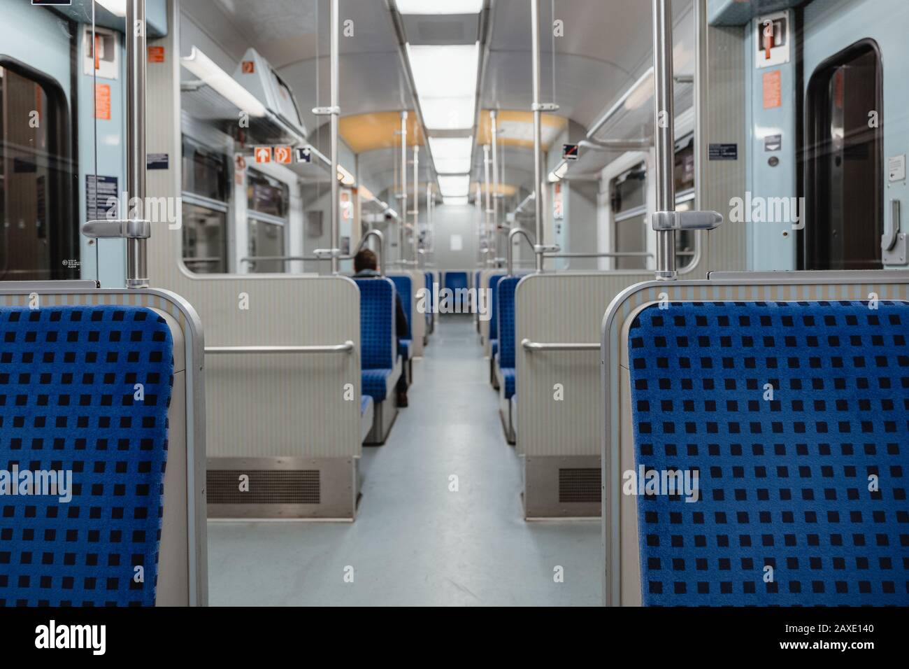 Interior view of a corridor inside passenger trains with blue fabric ...