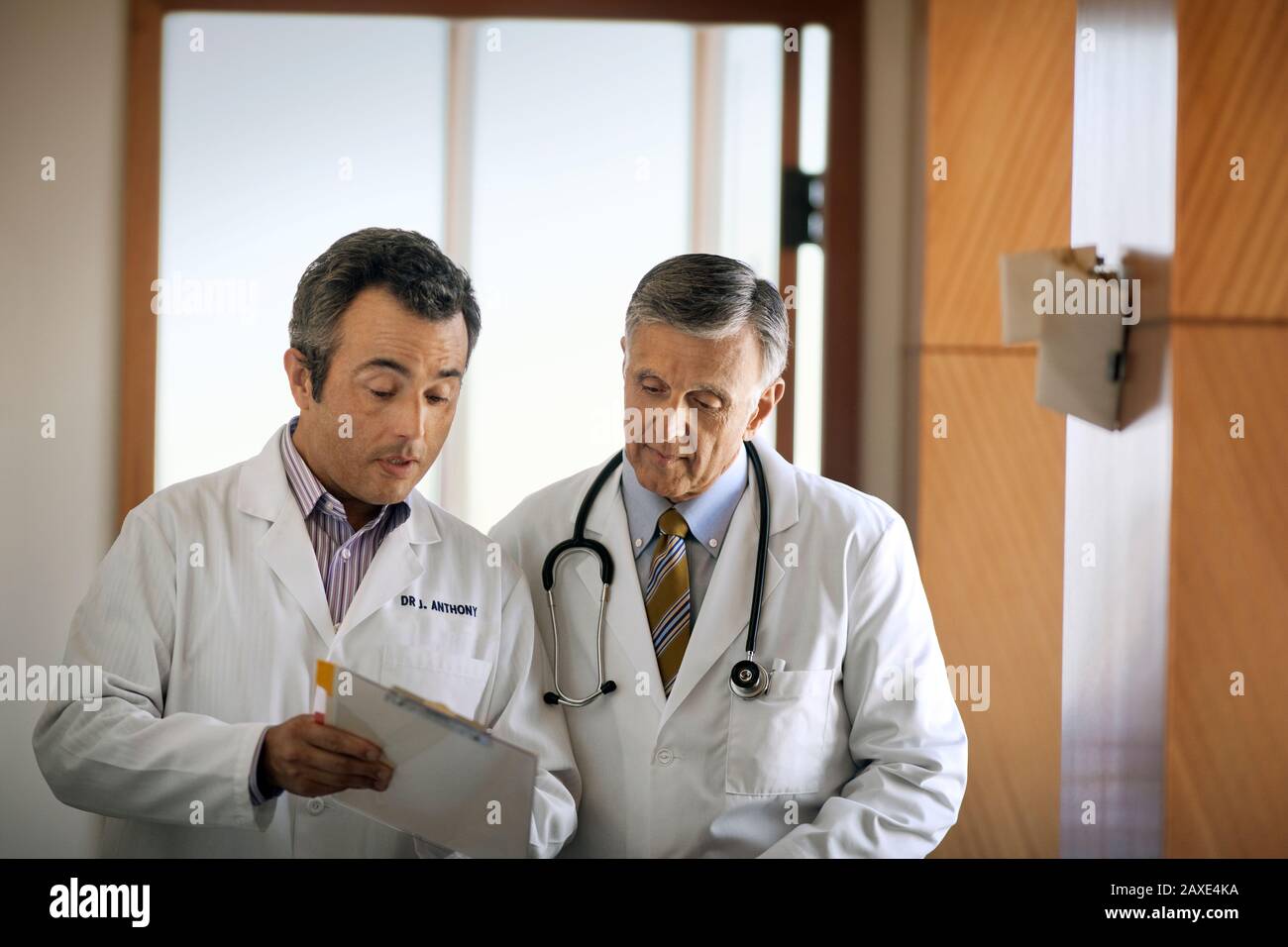 Two medical doctor's looking over a patient's notes Stock Photo - Alamy